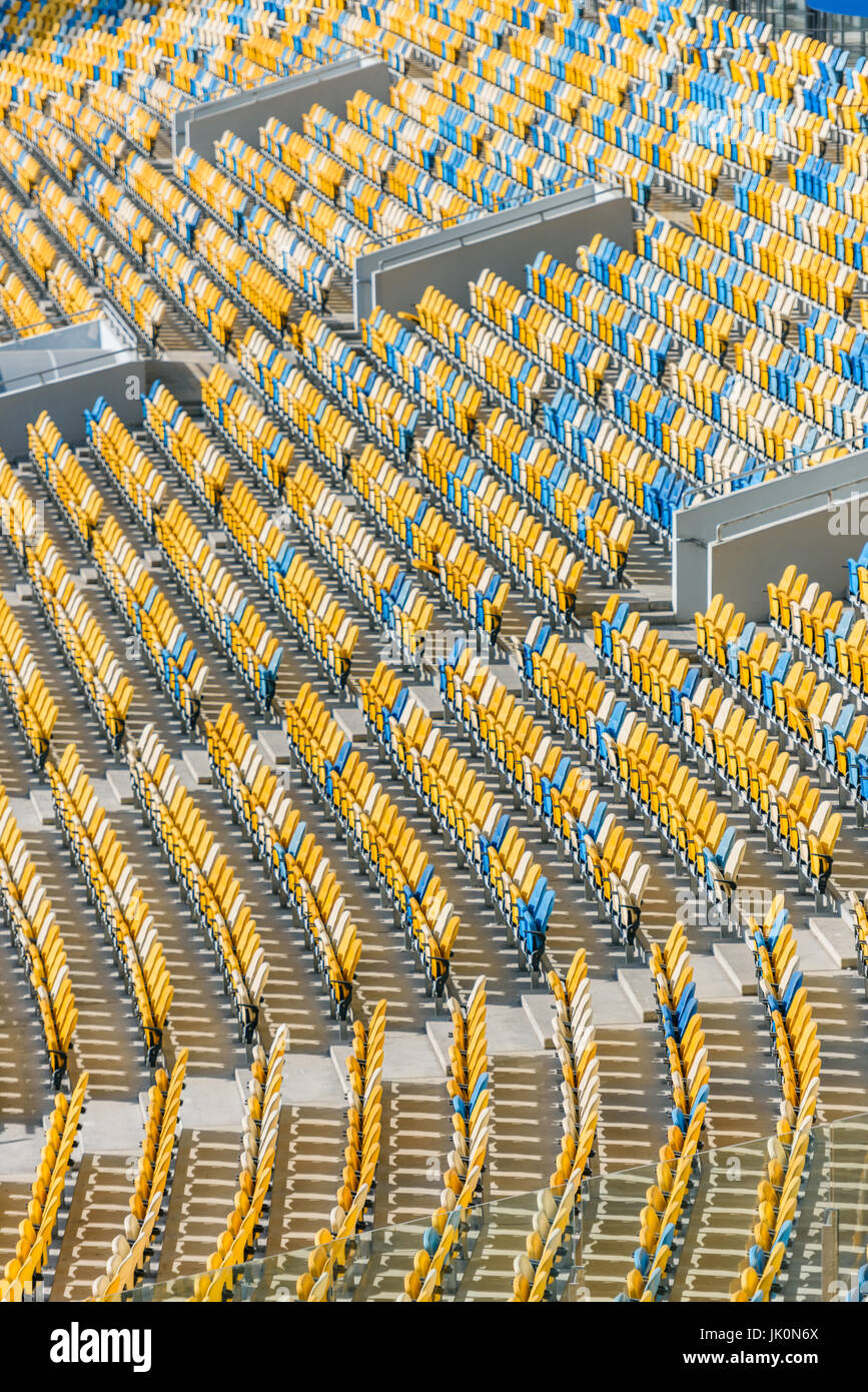 rows of yellow and blue stadium seats and stadium stairs Stock Photo ...
