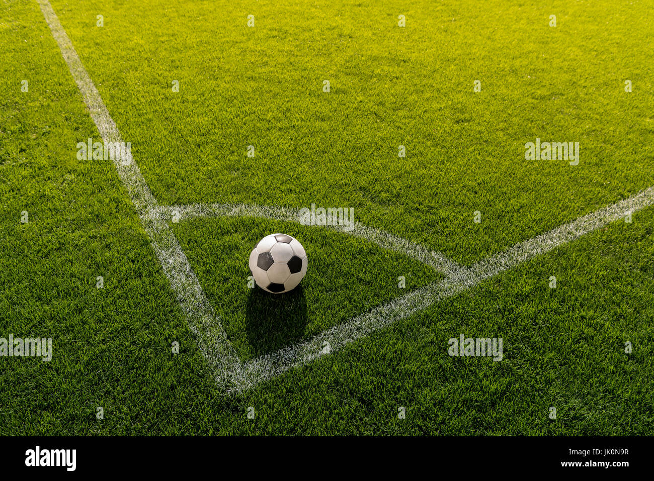 soccer ball on grass in corner kick position on soccer field stadium ...
