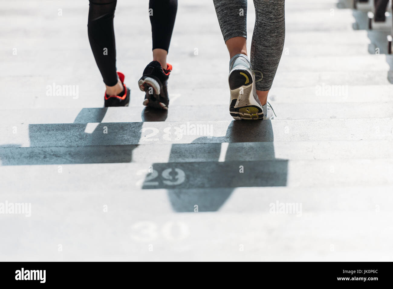 low section of two young sportswomen on stadium stairs Stock Photo - Alamy
