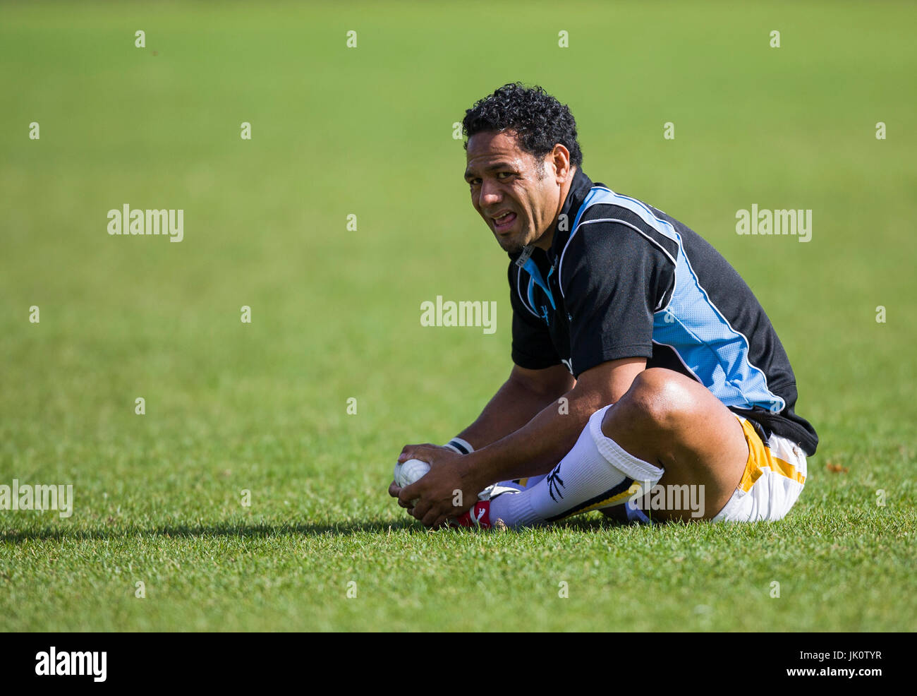 Fugby player stretching gluteus muscles and hamstrings. Rugby Union ...