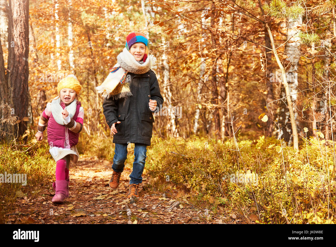 Kids running through forest path Stock Photo - Alamy