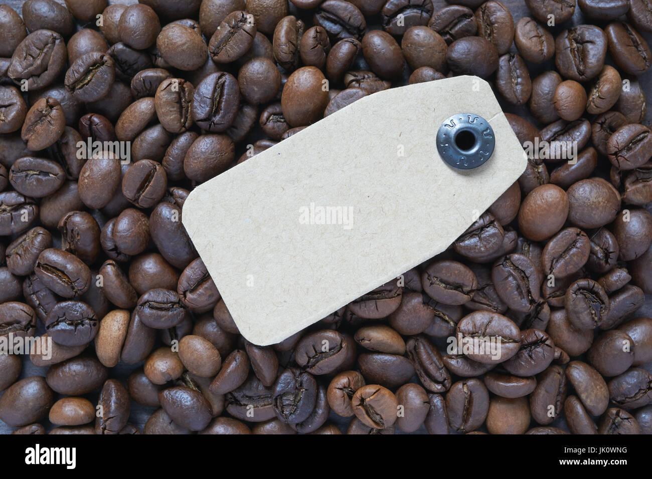 cardboard tag lay on brown roasted coffee beans. label for different ...