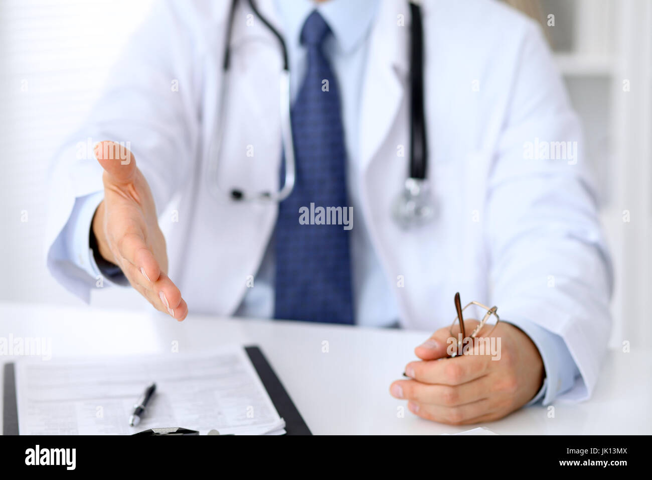 Male medicine doctor offering helping hand for handshake. Partnership ...