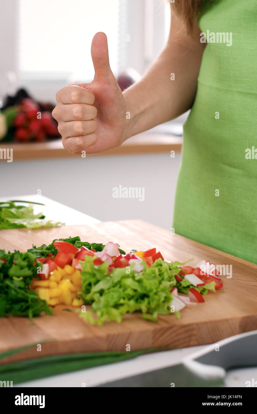 Close up of woman's hands cooking in the kitchen. Housewife offering ...
