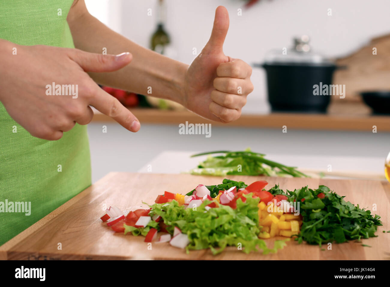 Close up of woman's hands cooking in the kitchen. Housewife offering ...