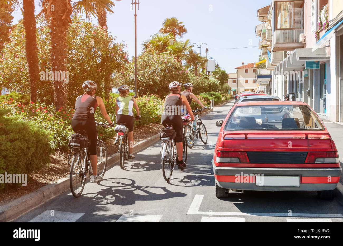 A group of cyclists rides through the city Stock Photo - Alamy