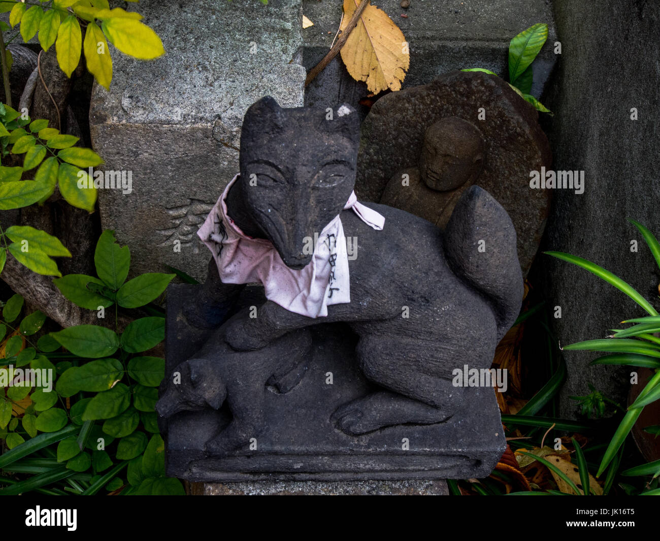 Sacred figurines, Kitsune fox guardian and buddhist statue, roadside ...