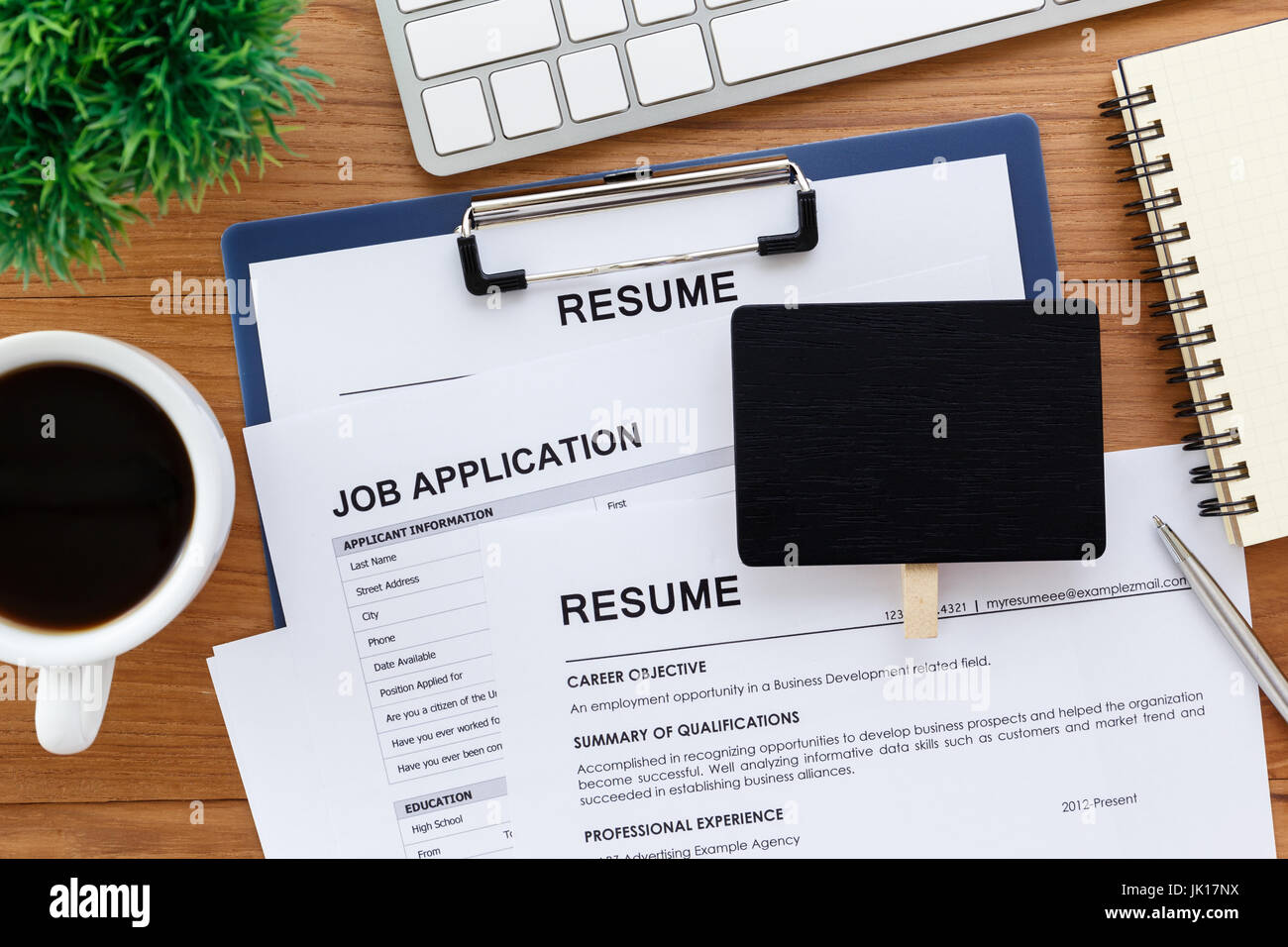 Resume and job application with blank sign on work desk Stock Photo - Alamy