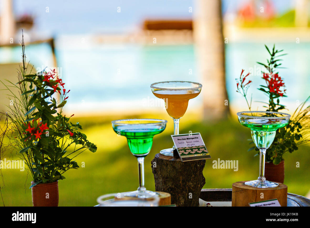 Glasses of color cocktails on pool background Stock Photo - Alamy