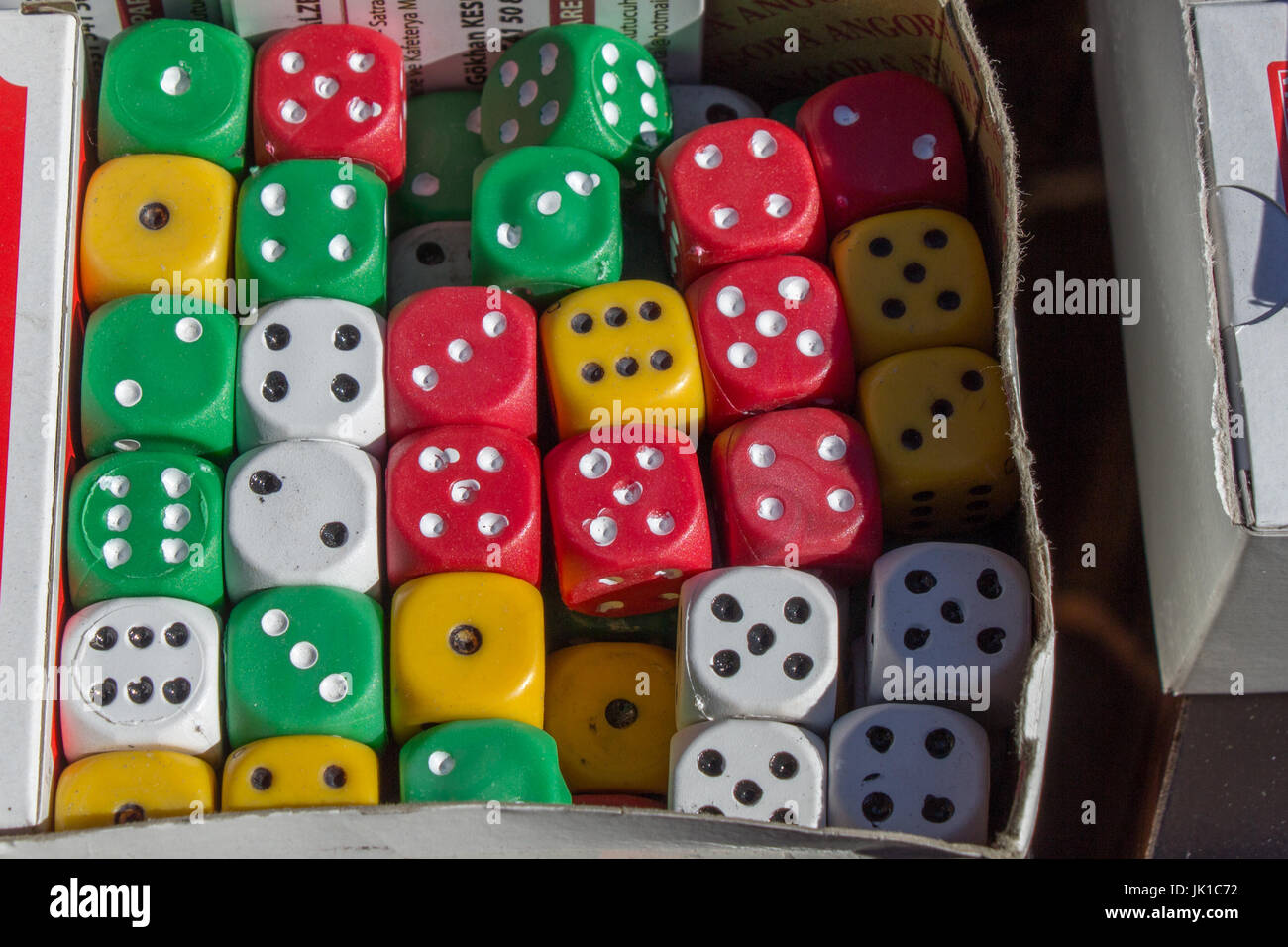 Many color dice on a table on a sunny day Stock Photo - Alamy