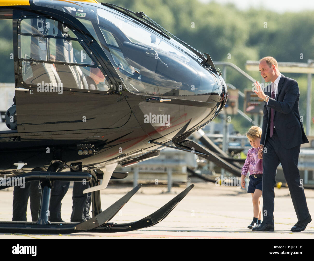 The Duke of Cambridge shows Prince George a rescue helicopter during a ...
