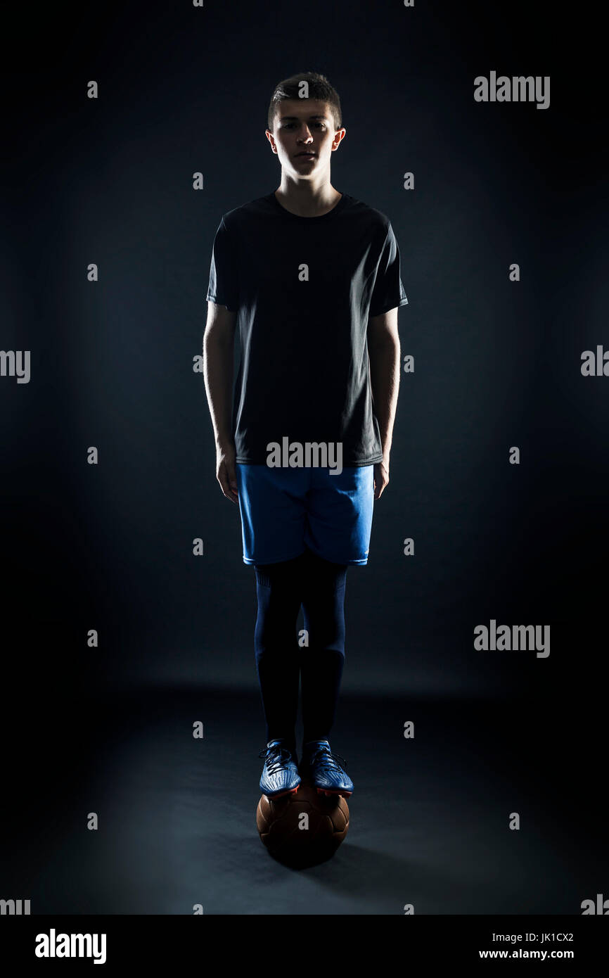 portrait of football player balanced on ball Stock Photo - Alamy