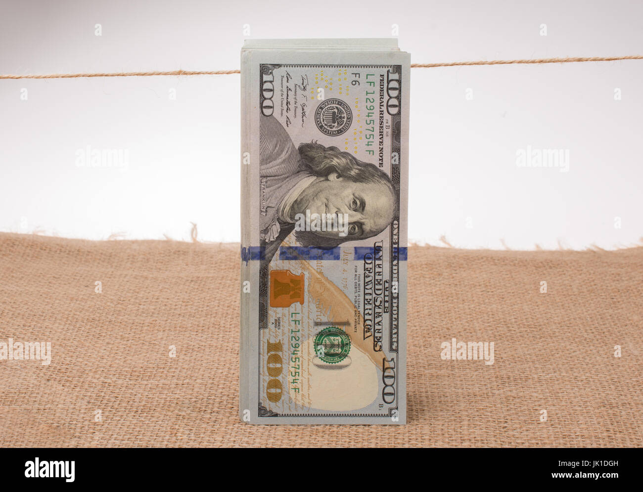 Banknote of US dollar hanging on a linen string Stock Photo - Alamy