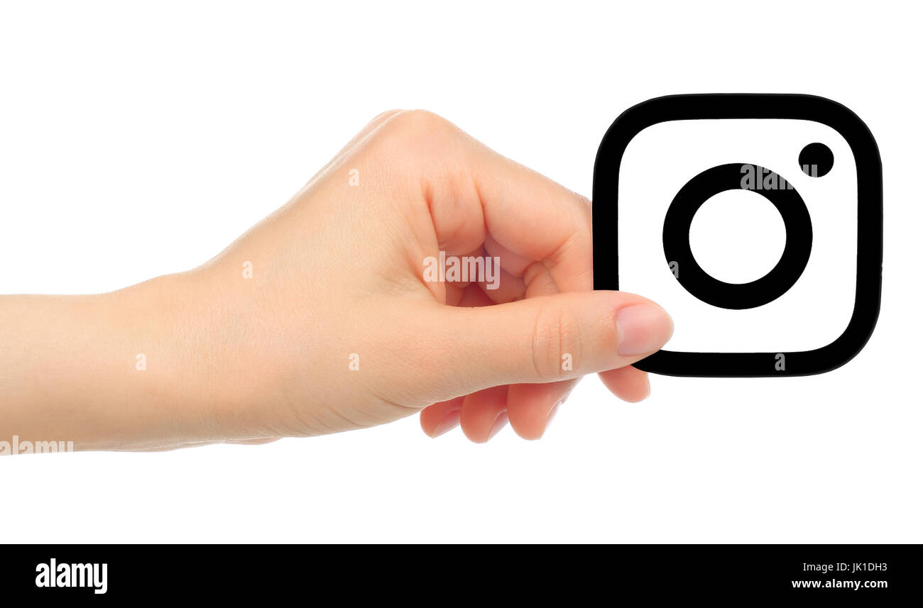 Kiev, Ukraine - May 17, 2016: Hand hold Instagram icon printed on paper ...