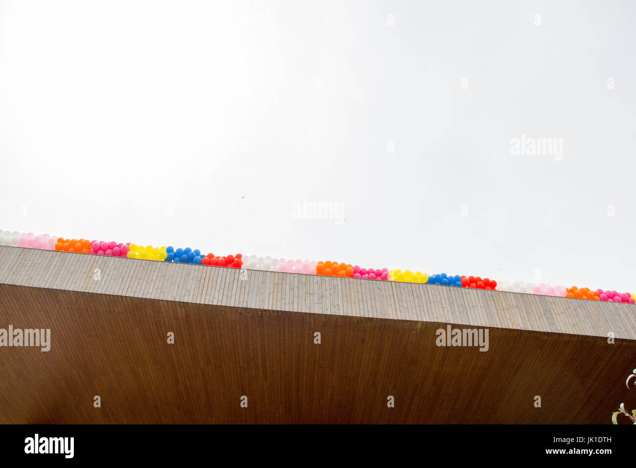 Color balloons on the roof of a building Stock Photo - Alamy
