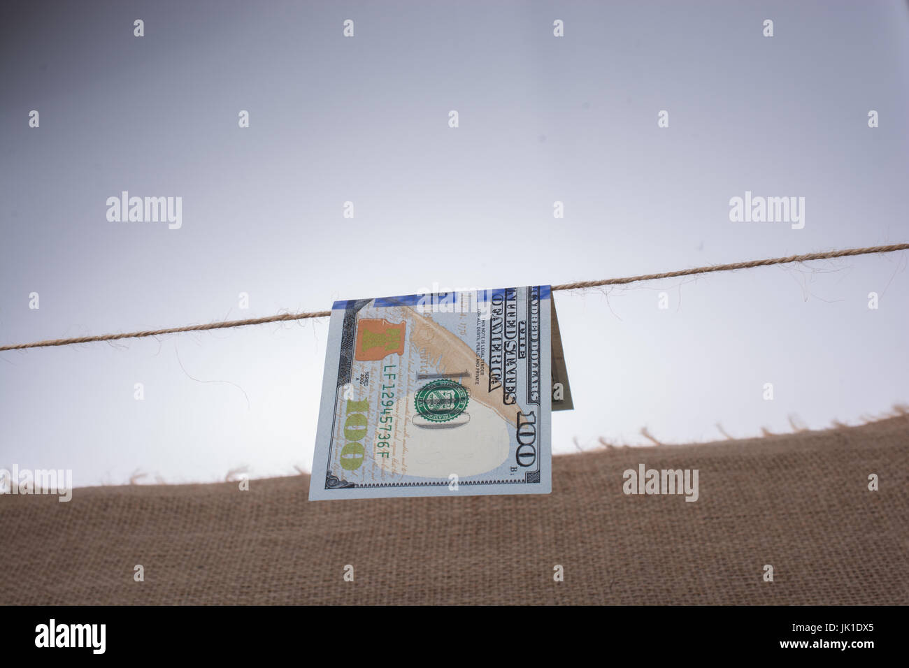 Banknote of US dollar hanging on a linen string Stock Photo - Alamy