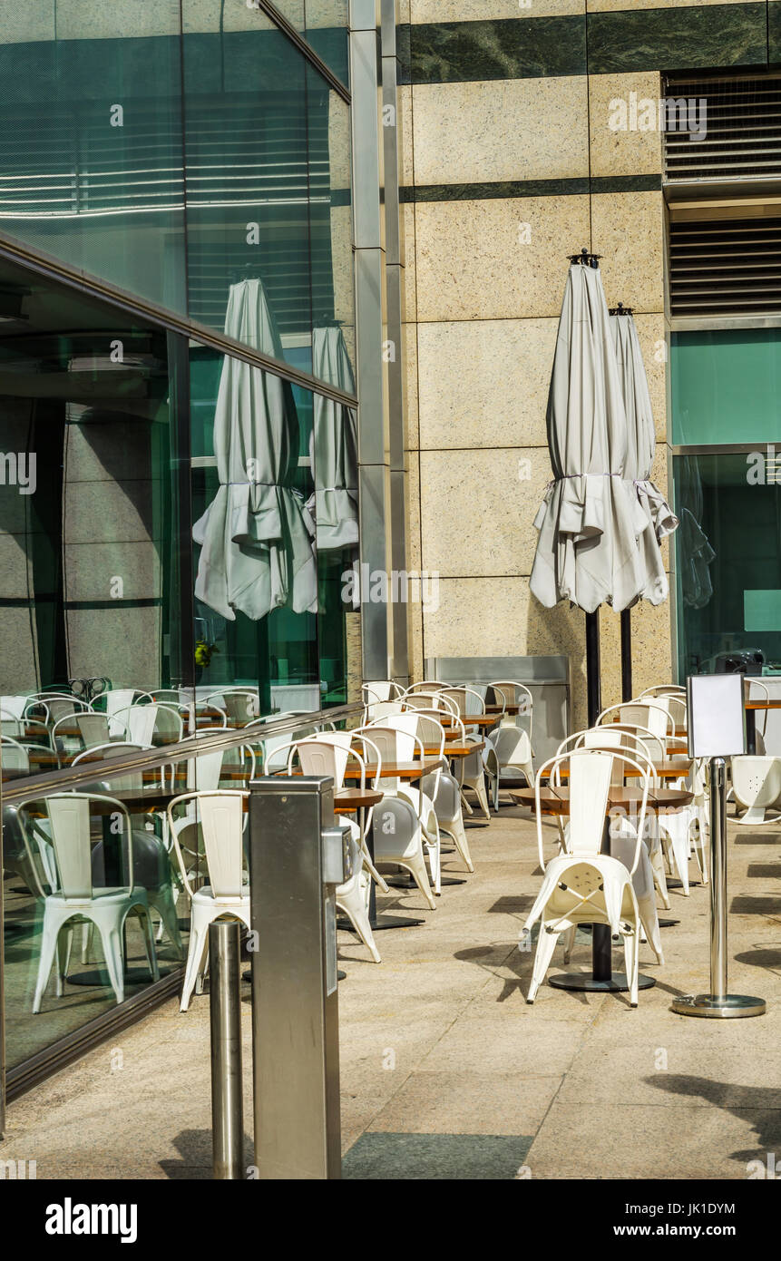 Empty tables and chairs in front of the restaurant, place to serve ...