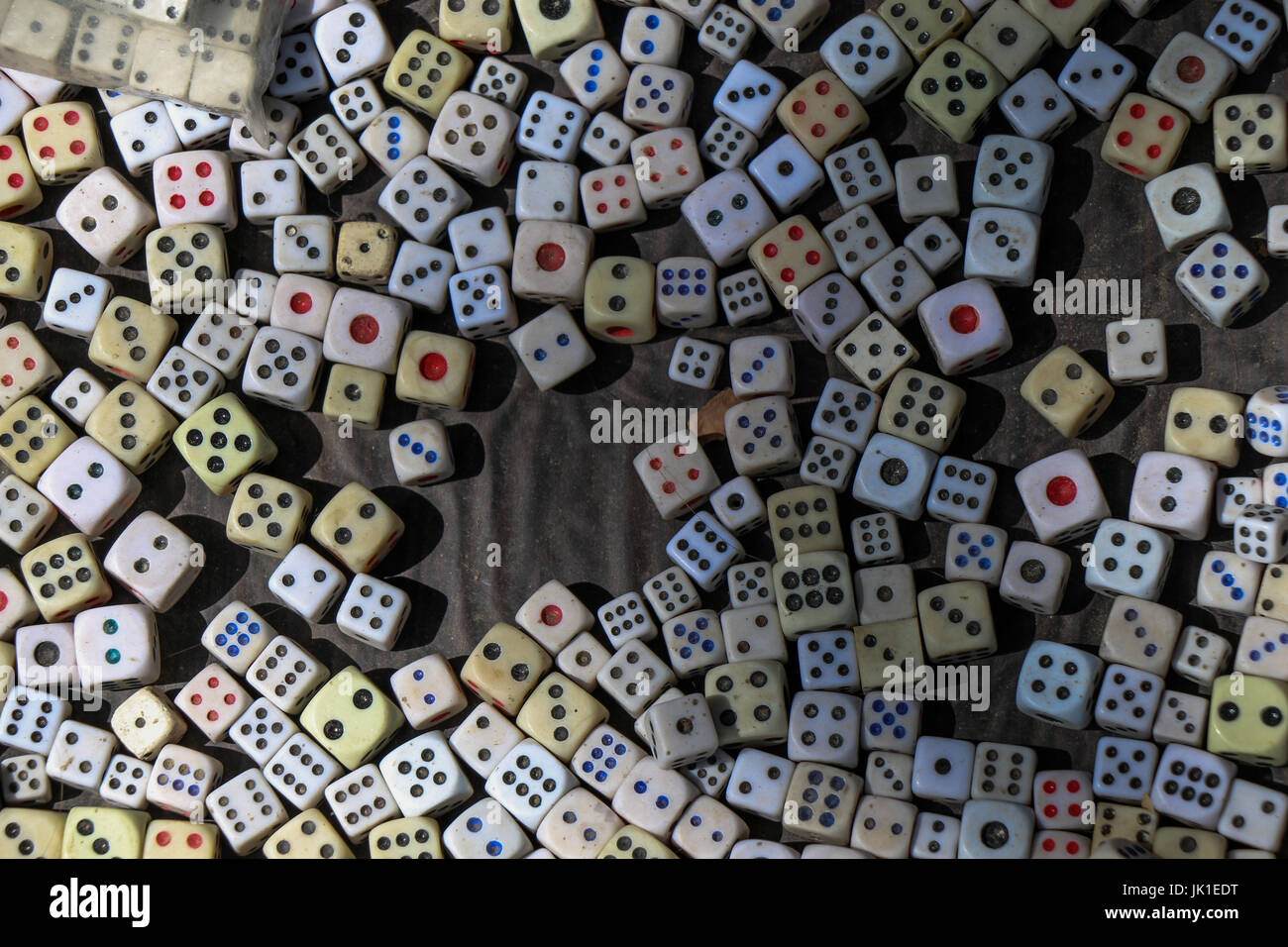 Many color dice on a table on a sunny day Stock Photo - Alamy