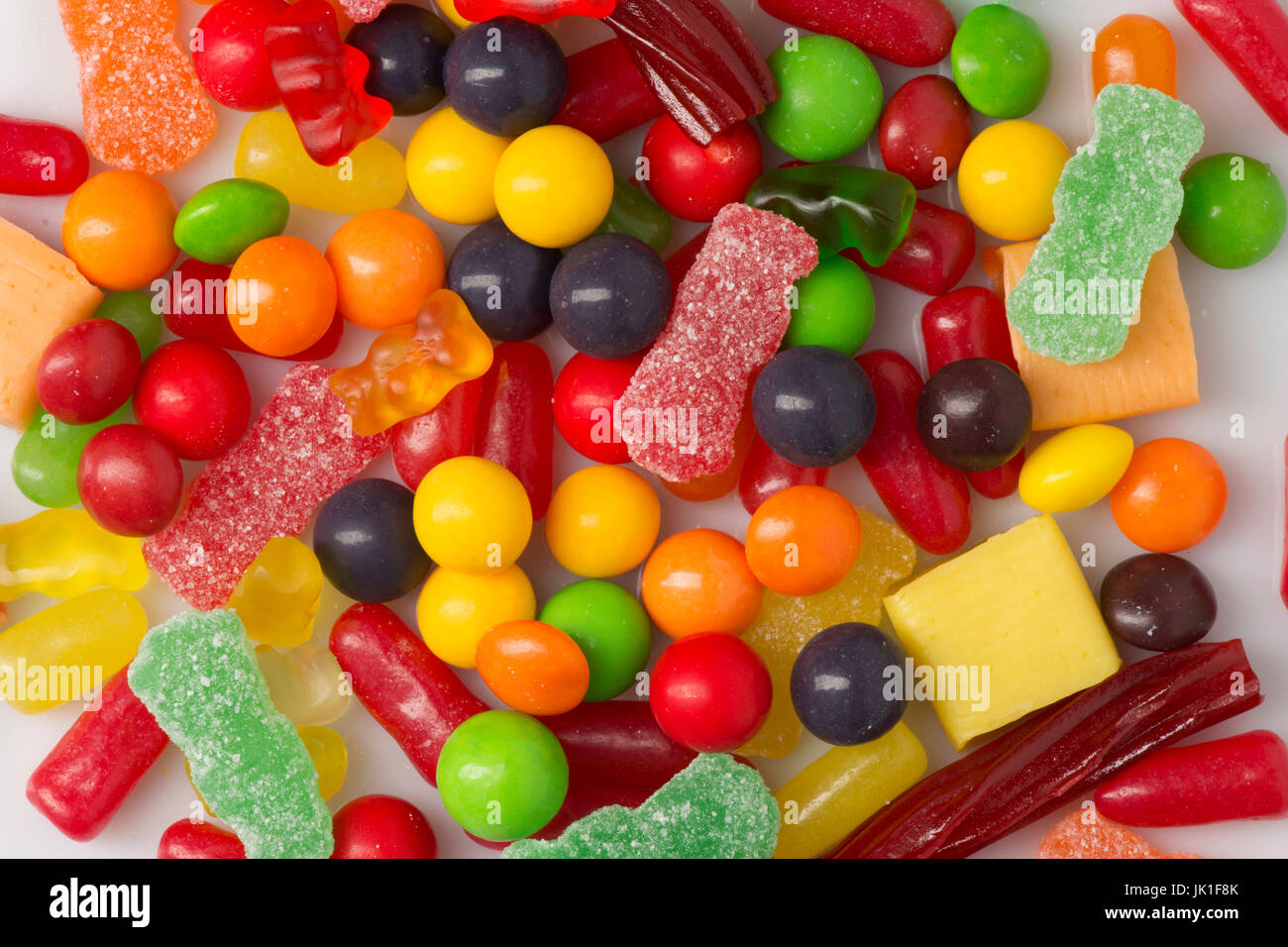 Various types of candy scattered on white, far away zoom Stock Photo ...