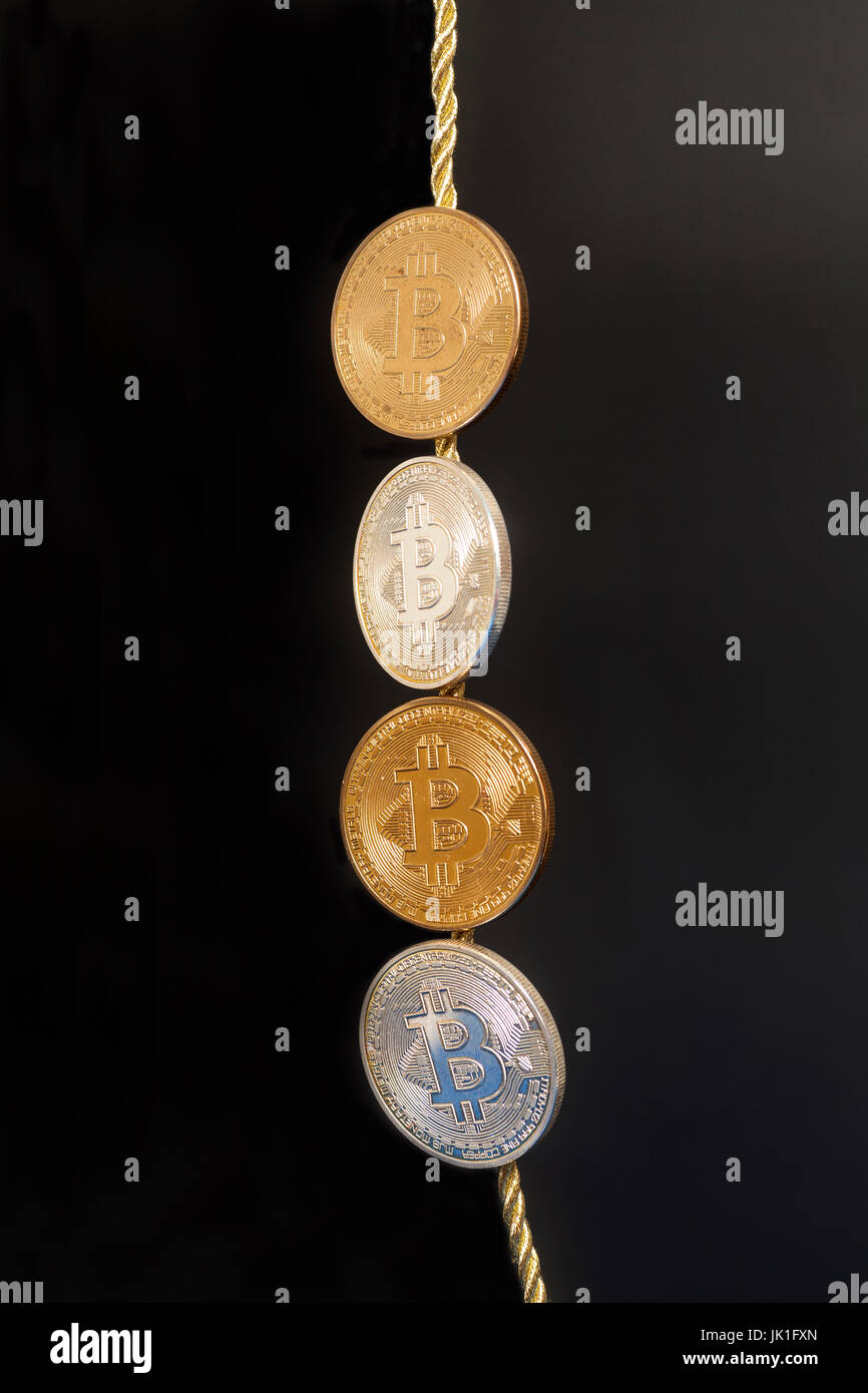 Four virtual coins bitcoins on black background Stock Photo - Alamy