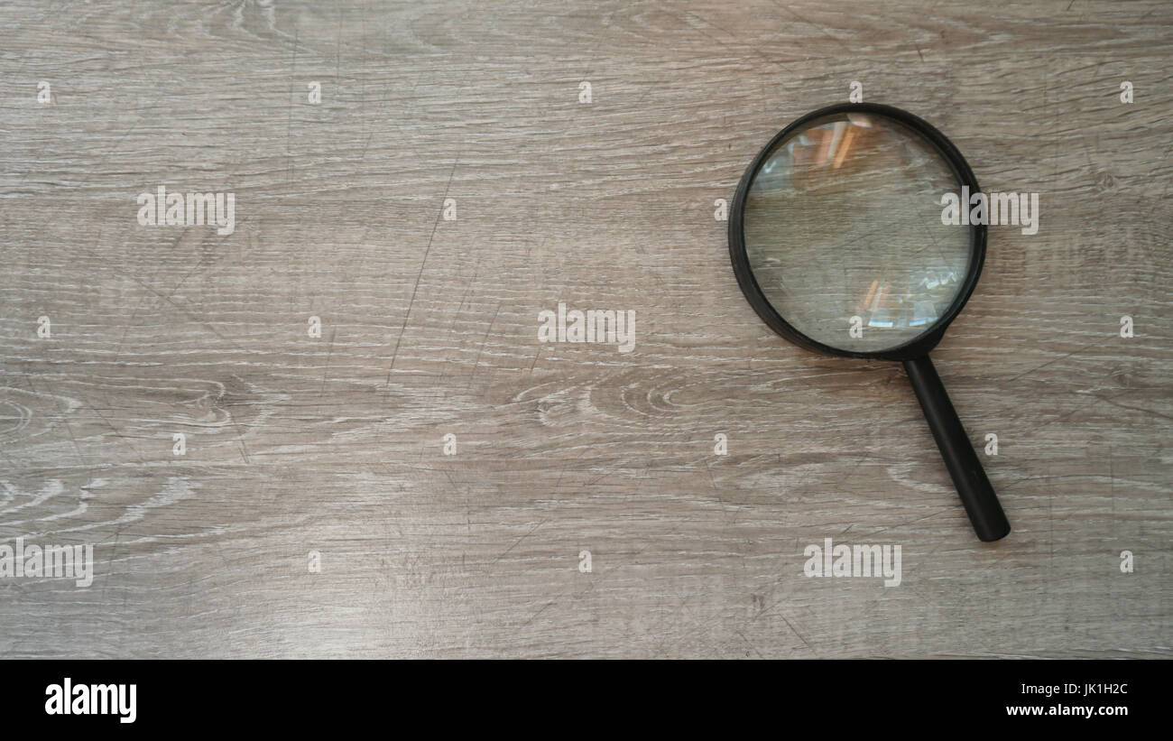 magnifying glass on the grey laminate background Stock Photo - Alamy