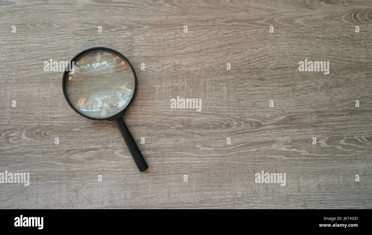 magnifying glass on the grey laminate background Stock Photo - Alamy