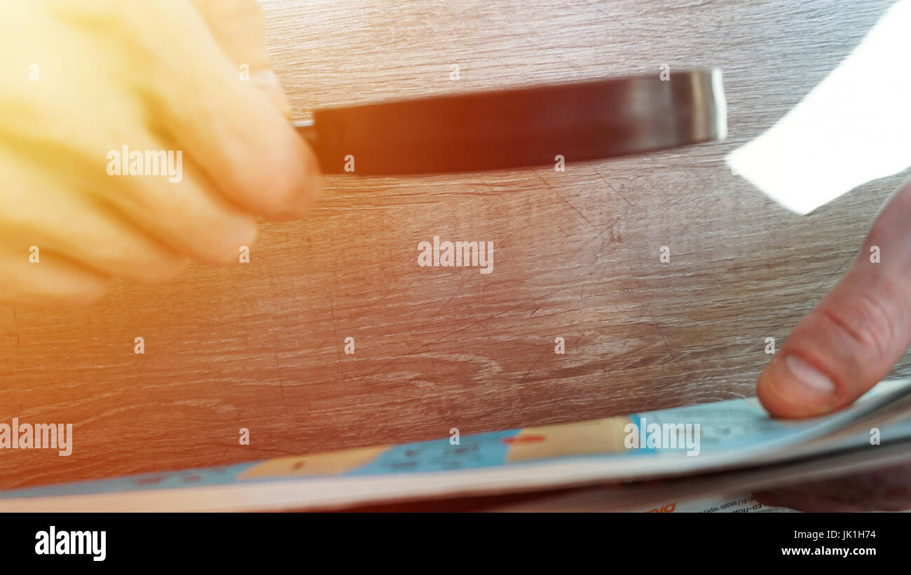 Businessman hand document and magnifier in office Stock Photo - Alamy
