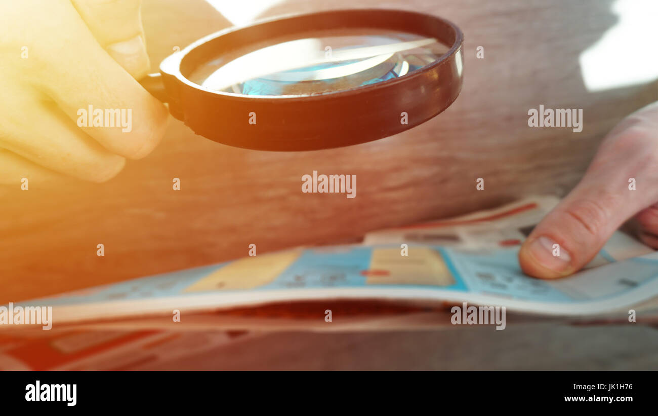 Businessman hand document and magnifier in office Stock Photo - Alamy