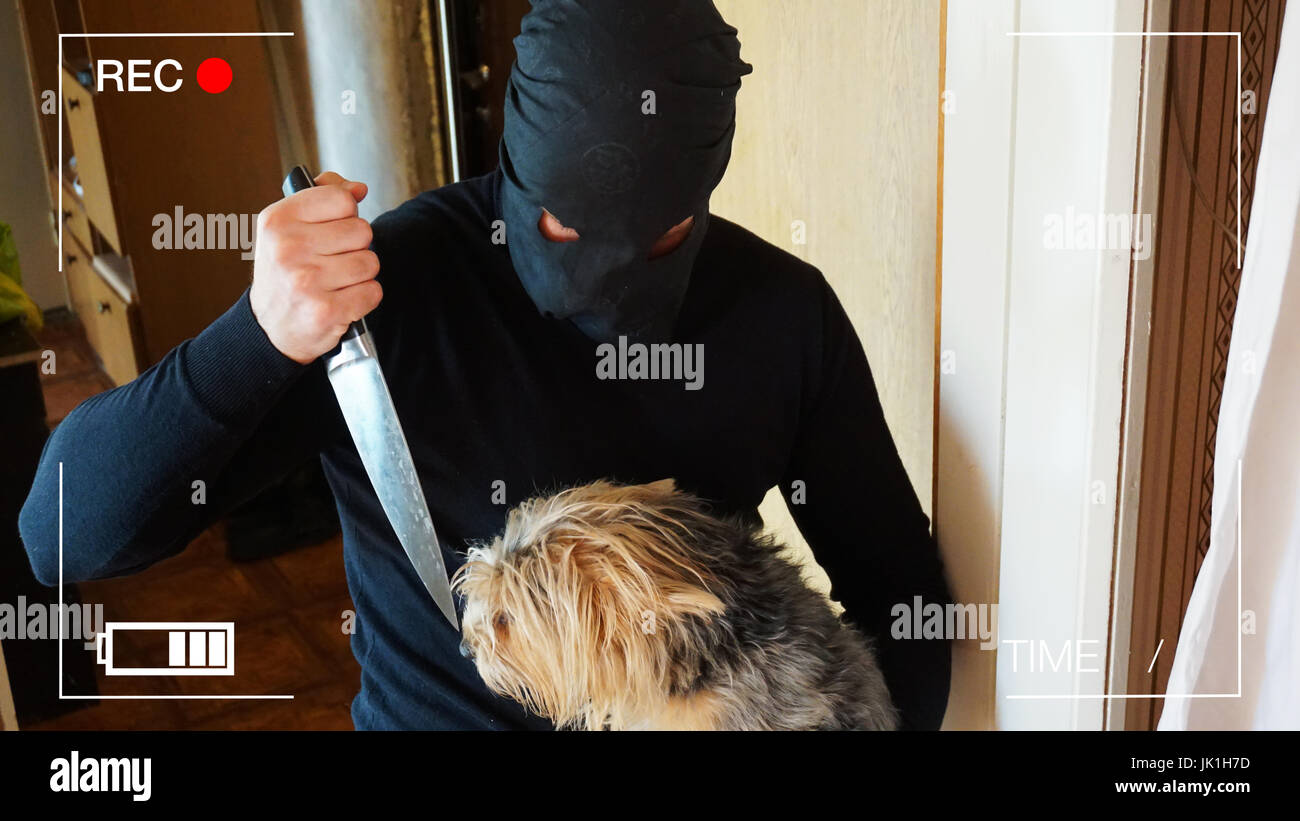 surveillance camera caught the robber in a mask with a knife,trying to ...