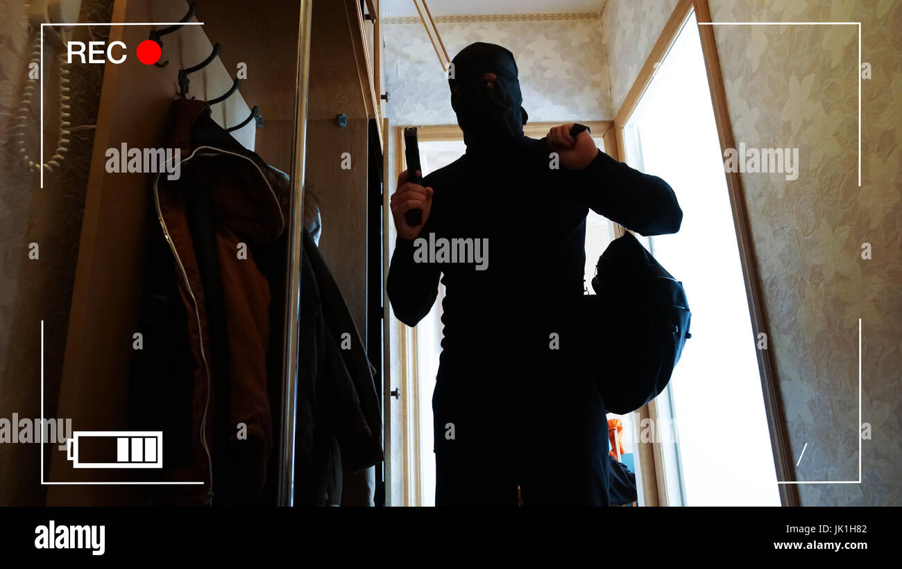 surveillance camera recorded the thief,who broke into the house with a ...