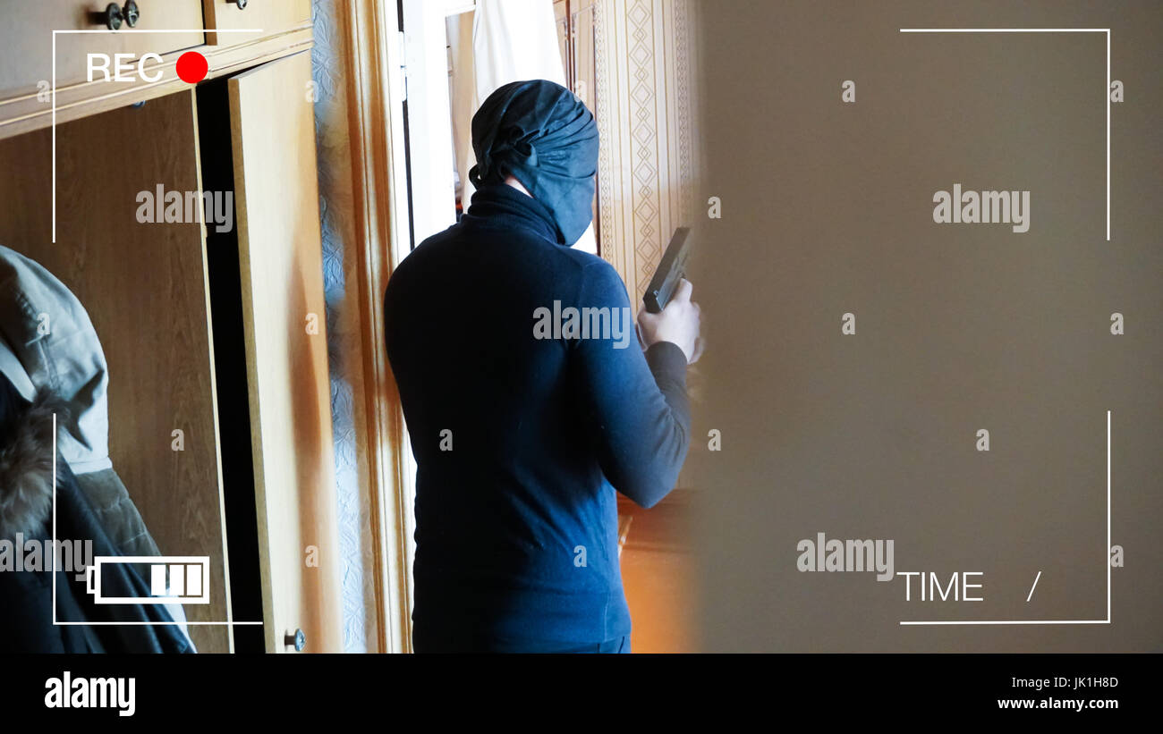 surveillance camera recorded the thief,who broke into the house with a ...