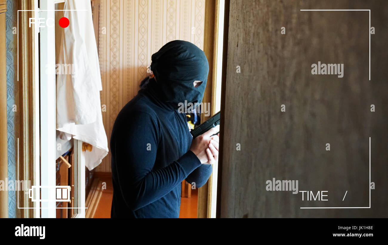 surveillance camera recorded the thief,who broke into the house with a ...