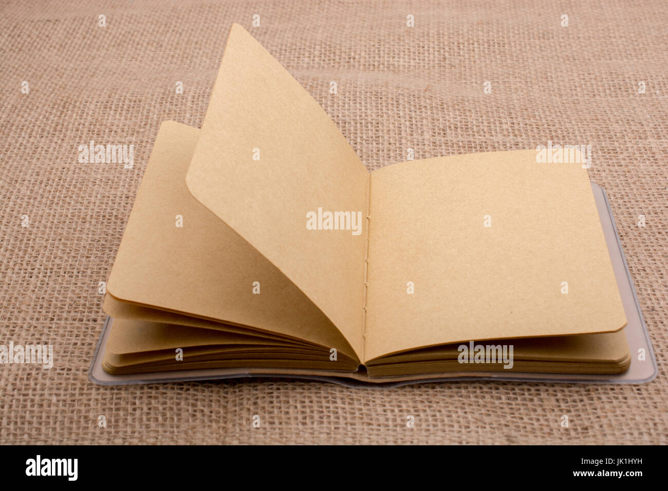 brown color notebook placed on a canvas background Stock Photo - Alamy