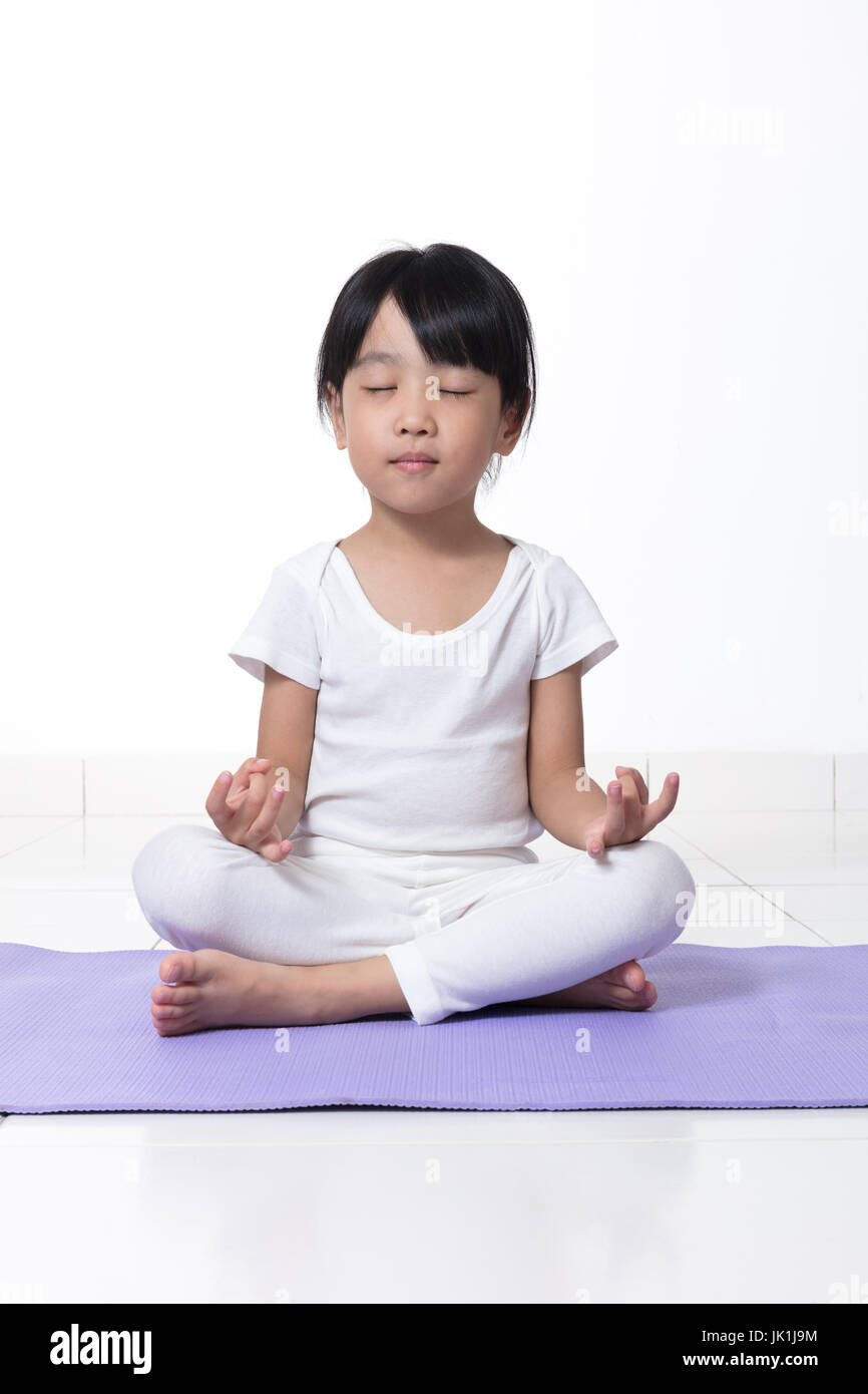 Asian Chinese little girl practicing yoga pose on a mat indoor Stock ...