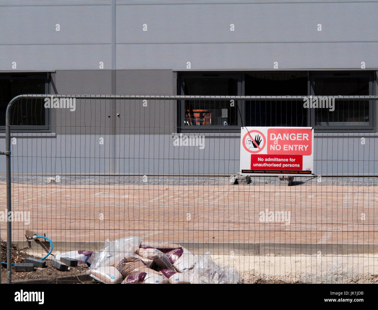 Danger no entry sign mounted on security fencing, new commercial ...