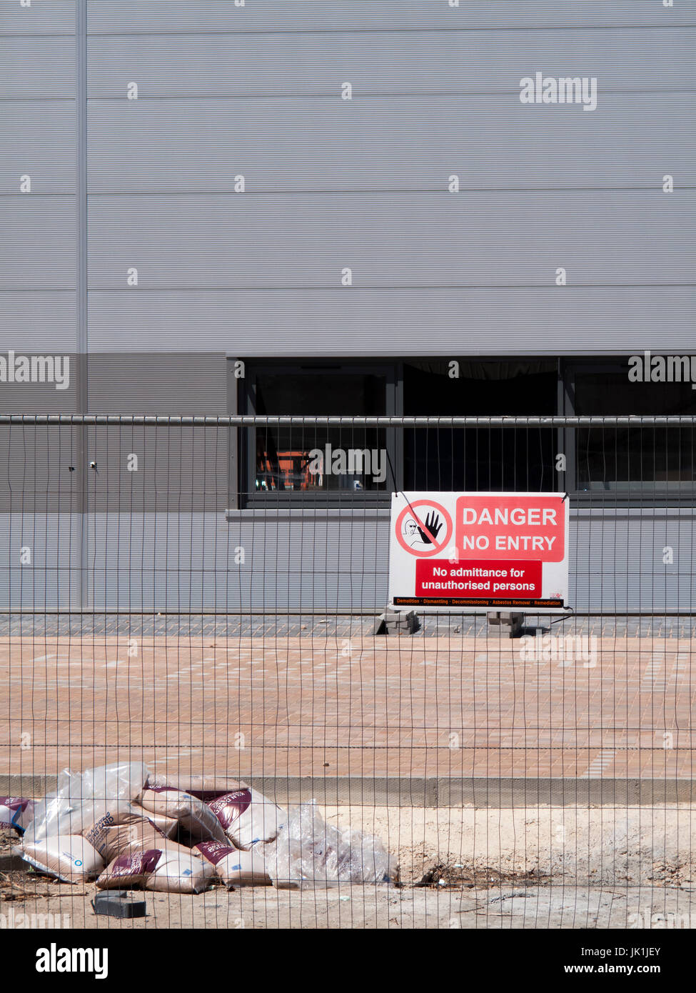 Danger no entry sign mounted on security fencing, new commercial ...