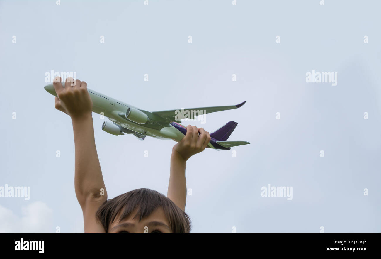 Kid playing with toy airplane. Kids playing with toy airplane at the ...