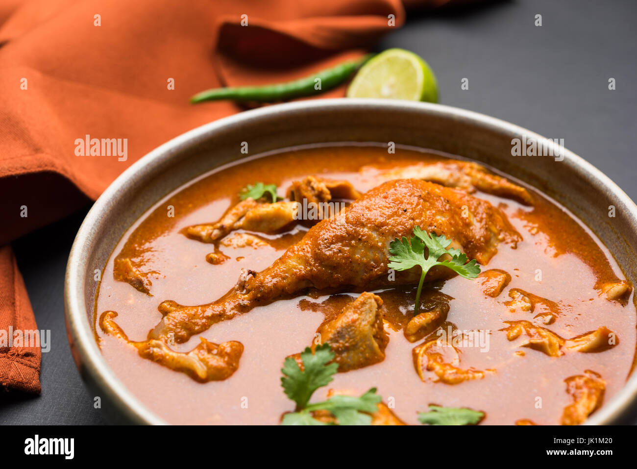 Indian spicy Chicken curry or masala chicken with prominent leg piece ...