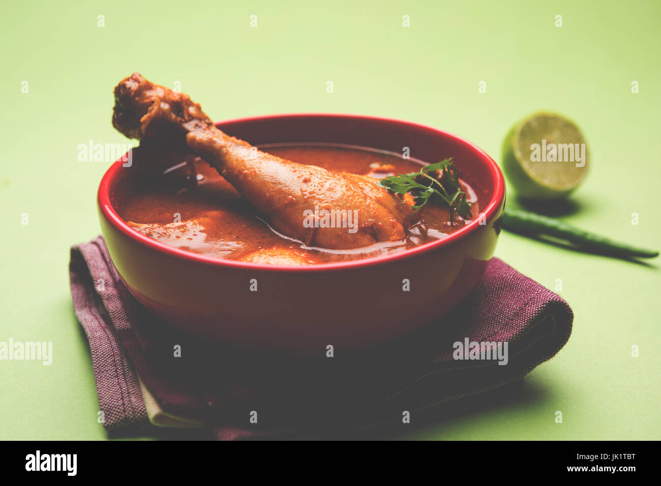 Indian spicy Chicken curry or masala chicken with prominent leg piece ...