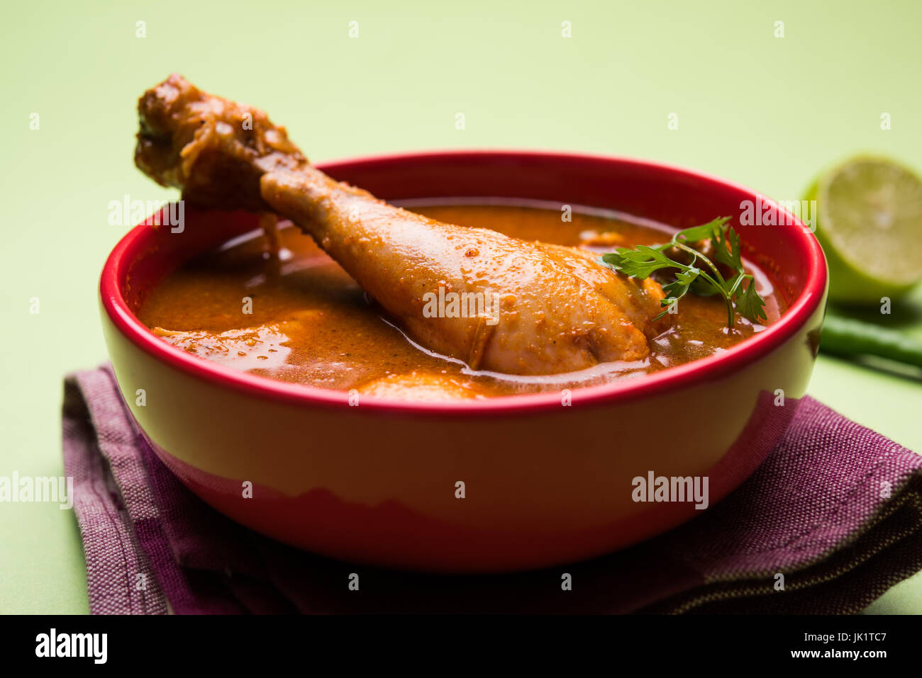 Indian spicy Chicken curry or masala chicken with prominent leg piece ...