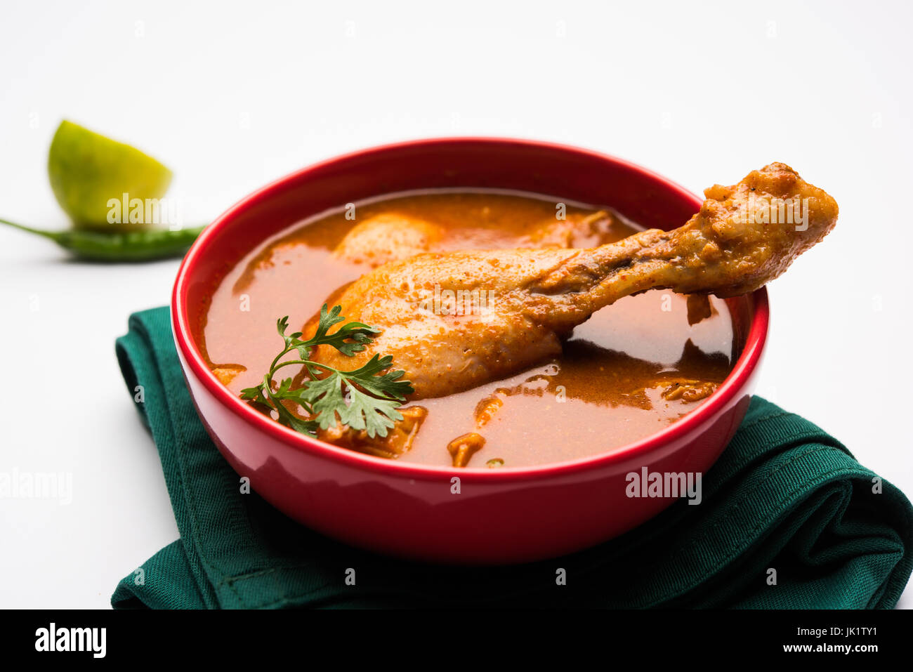 Indian spicy Chicken curry or masala chicken with prominent leg piece ...