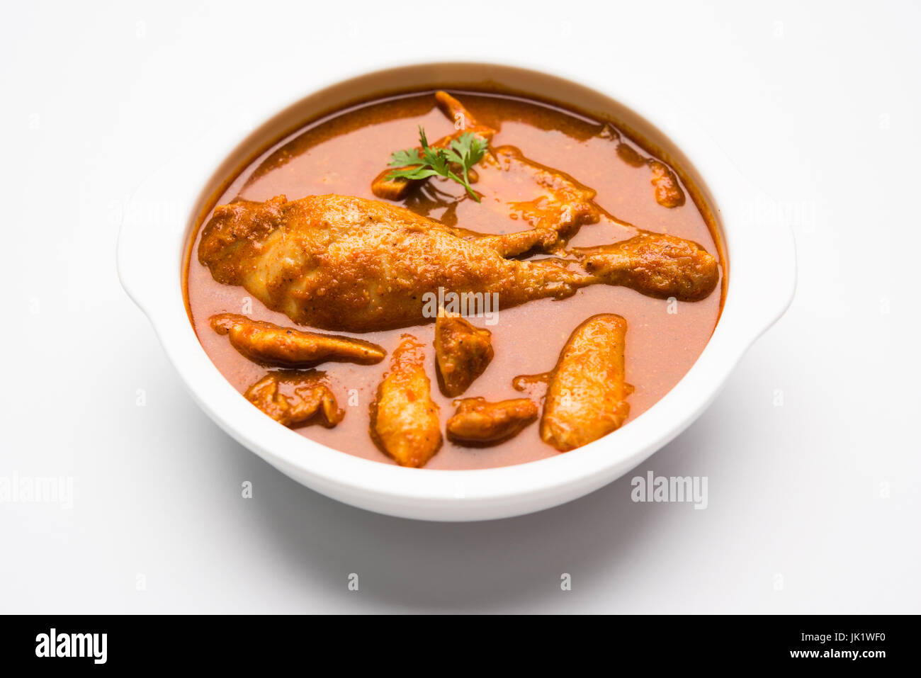 Indian spicy Chicken curry or masala chicken with prominent leg piece ...