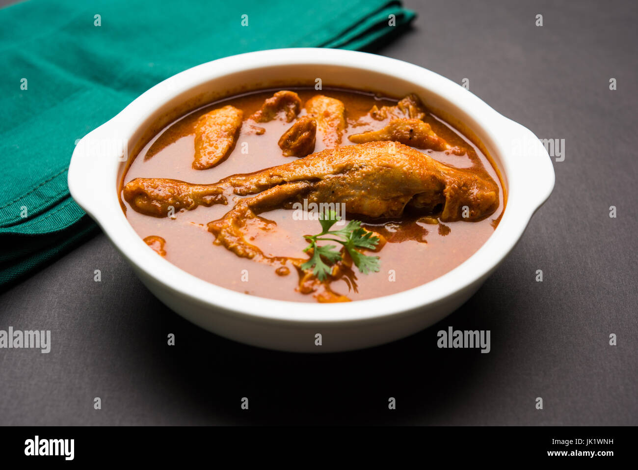 Indian spicy Chicken curry or masala chicken with prominent leg piece ...