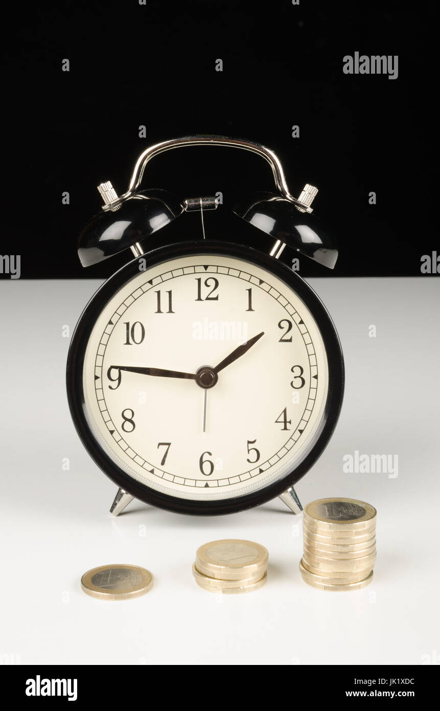 Vintage alarm clock in a time is money concept Stock Photo - Alamy