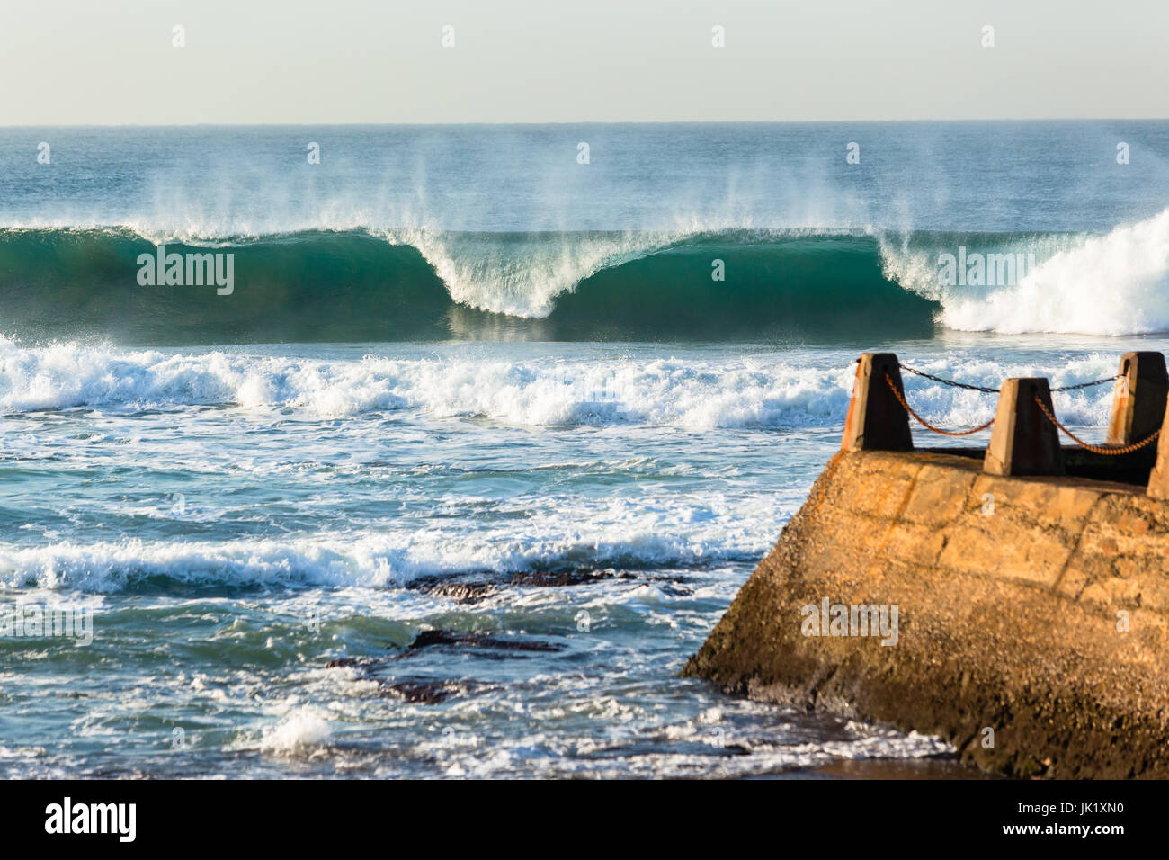 Waves crashing ocean water power front of tidal swimming pool Stock ...
