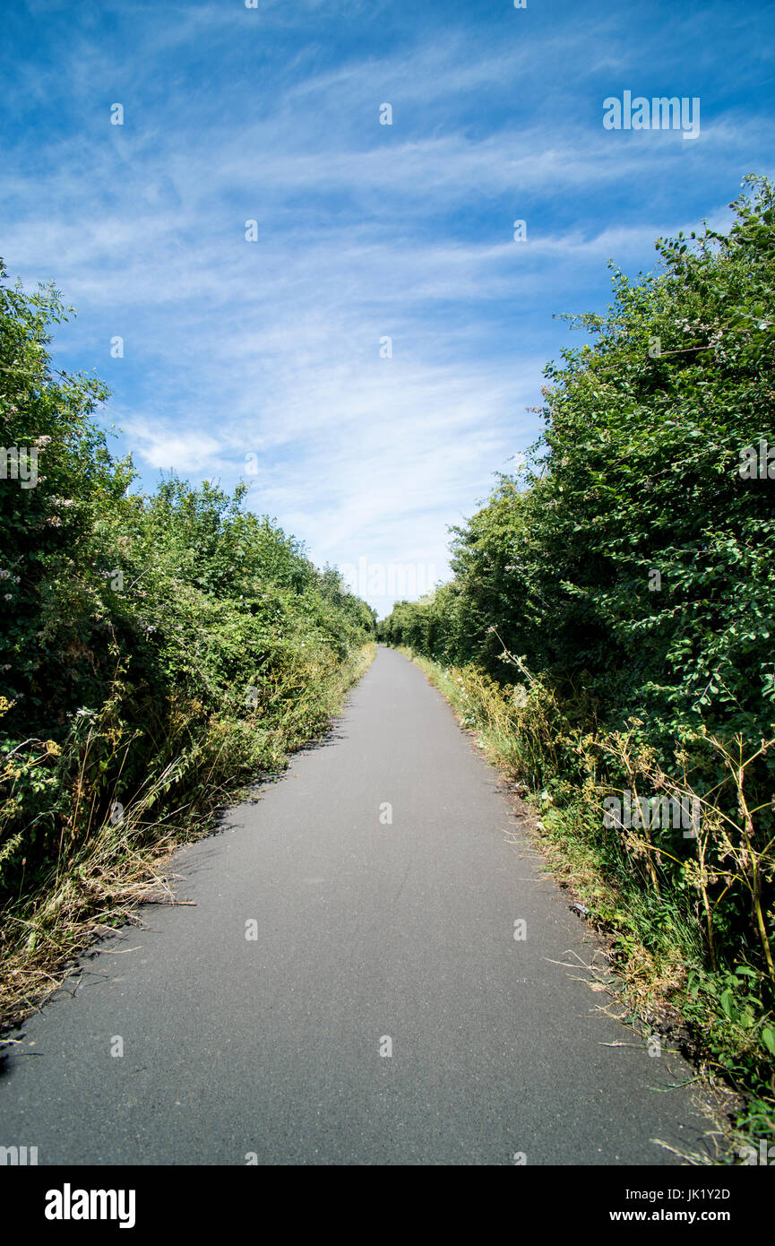narrow tarmac lane with hedgerows either side. Footpath, cycle path ...
