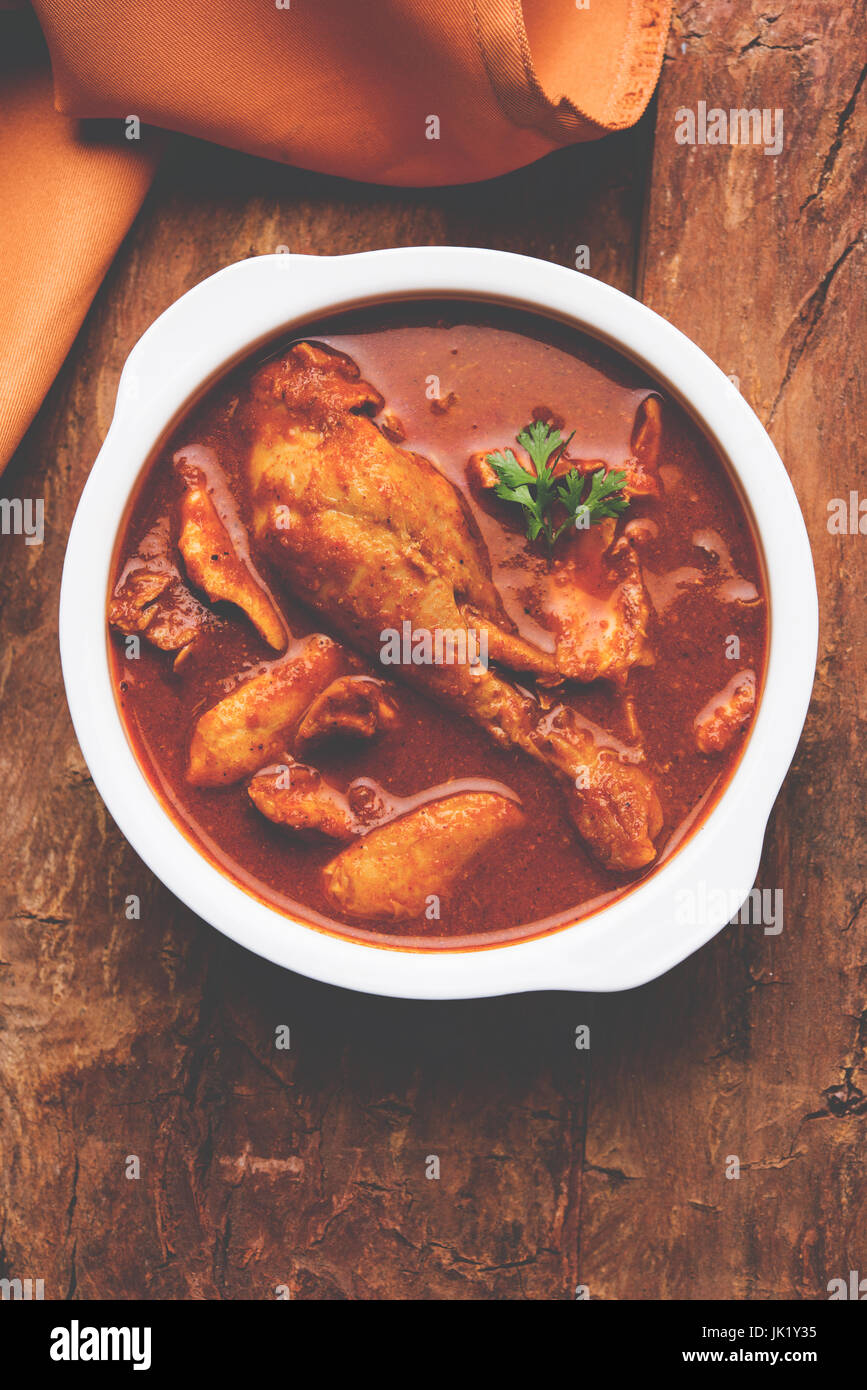 Indian spicy Chicken curry or masala chicken with prominent leg piece ...