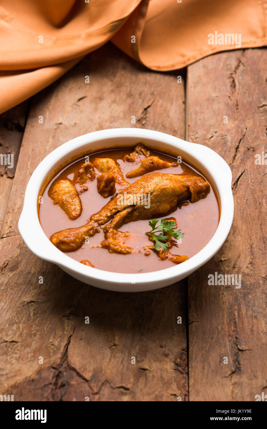 Indian spicy Chicken curry or masala chicken with prominent leg piece ...