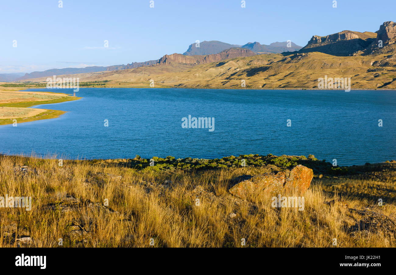 Arid prairie with glimpse of Shoshone river and Rocky Mountains as ...