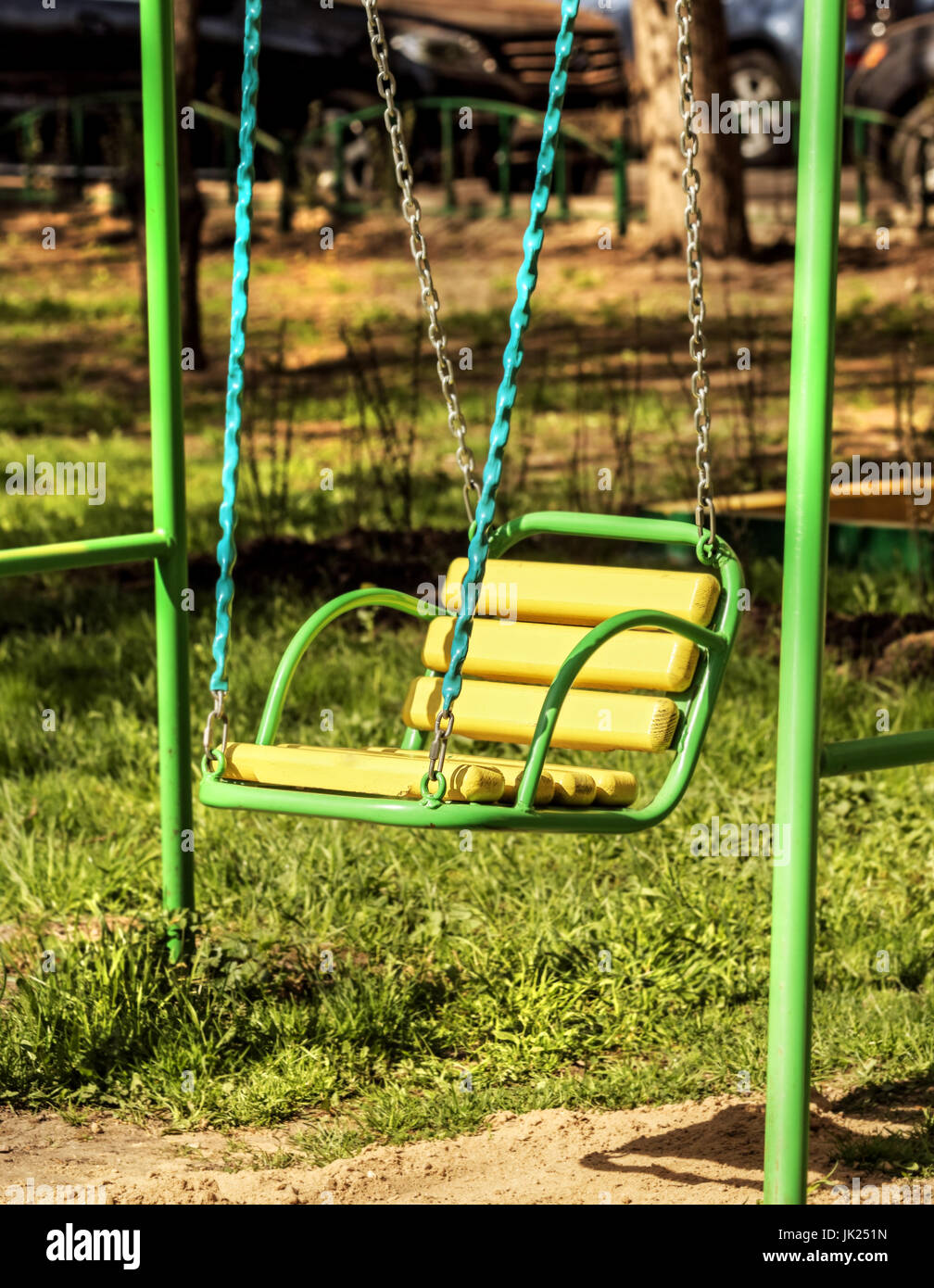 Yellow swing at sunny day Stock Photo - Alamy